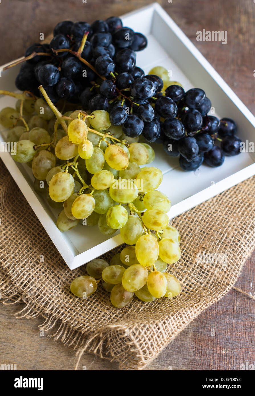 Ripe grape fruits on the dark vintage kitchen background Stock Photo ...