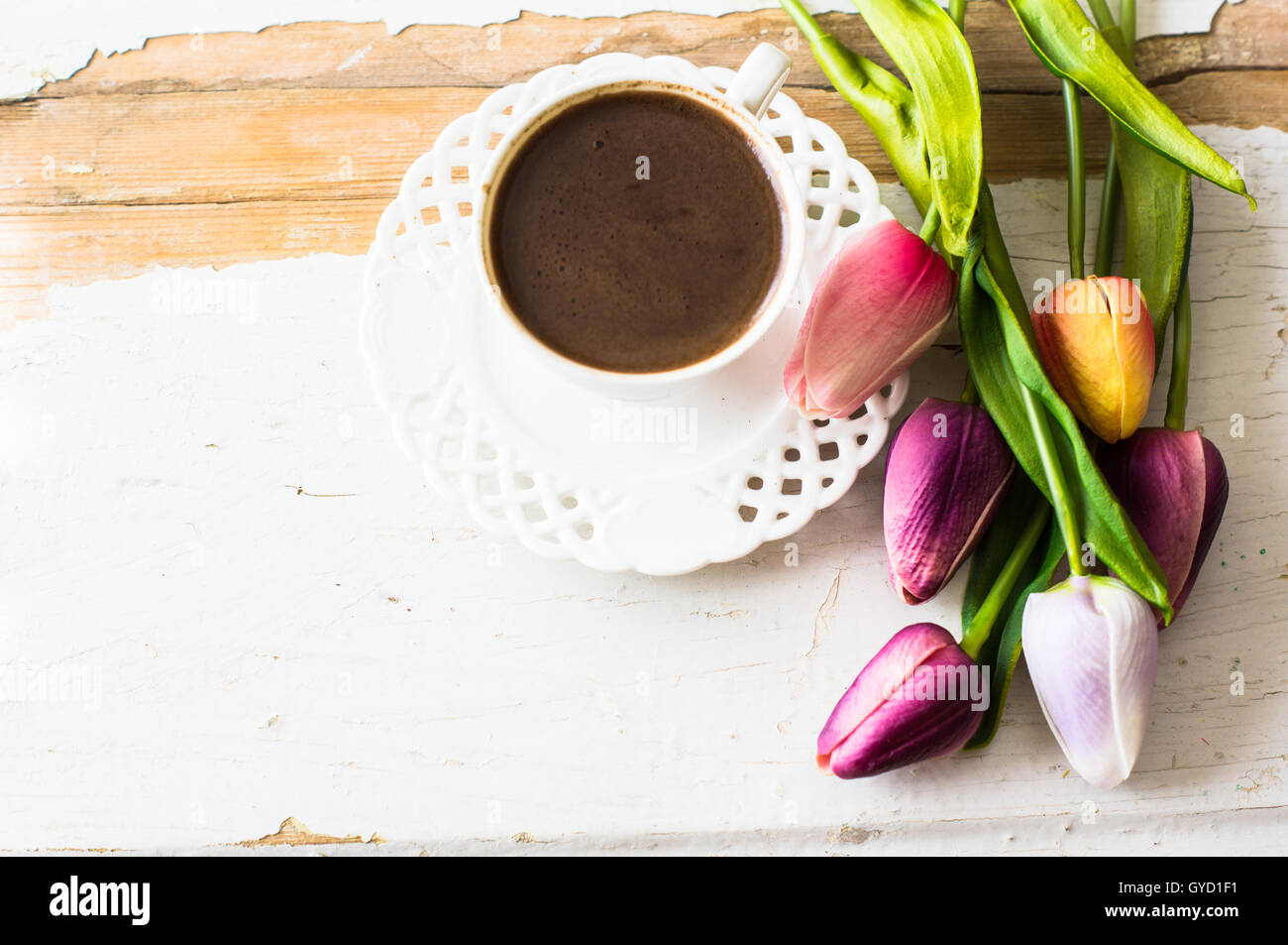 Cup of coffee with tulip flowers on rusty background Stock Photo - Alamy