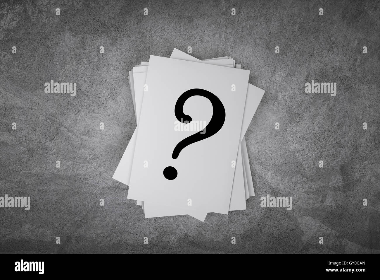 Paper card on a concrete table with question mark sign with free space ...