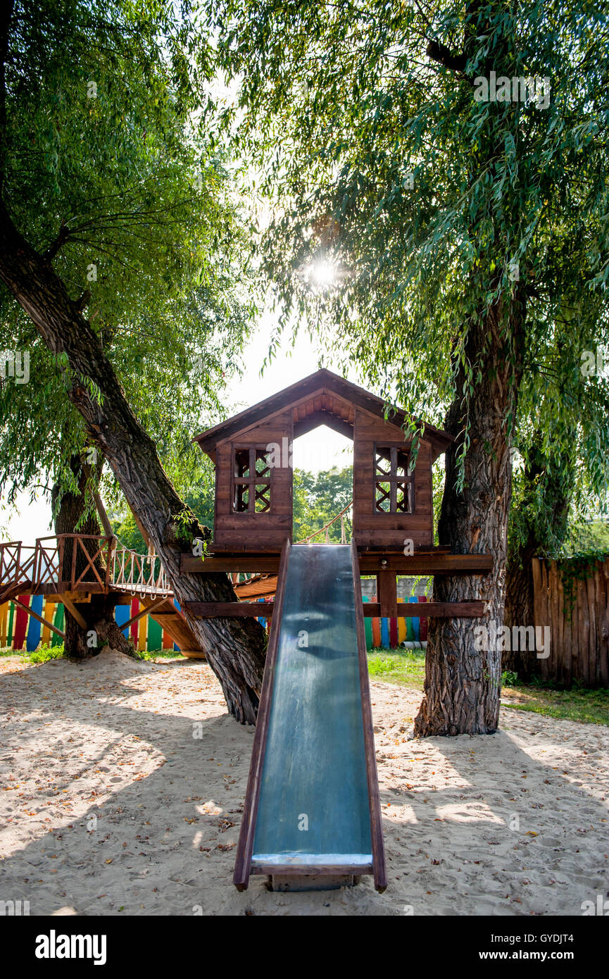 tree house with a slide on the playground at summer evening Stock Photo ...