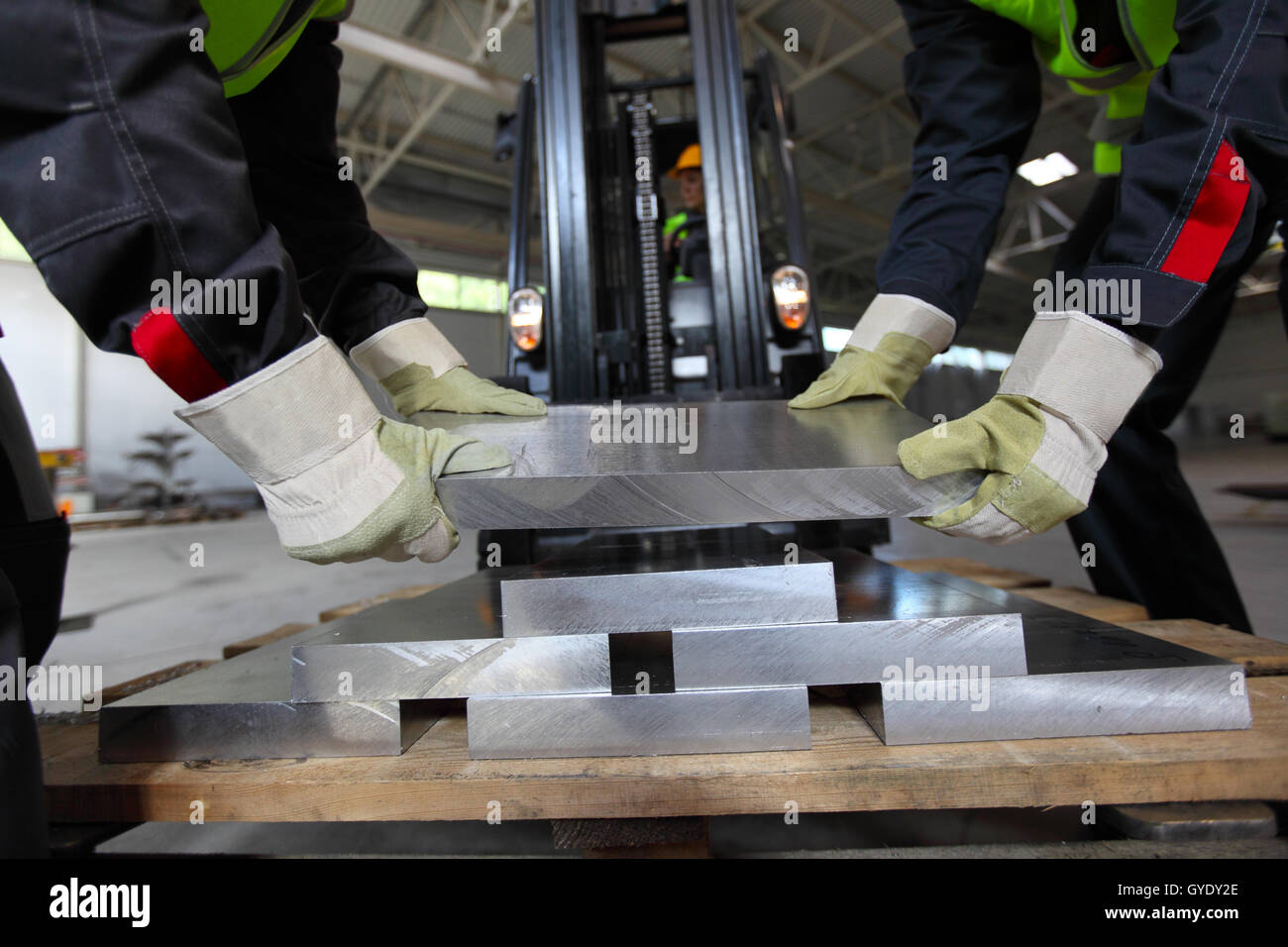 Workers taking aluminium billet at CNC machine shop Stock Photo - Alamy
