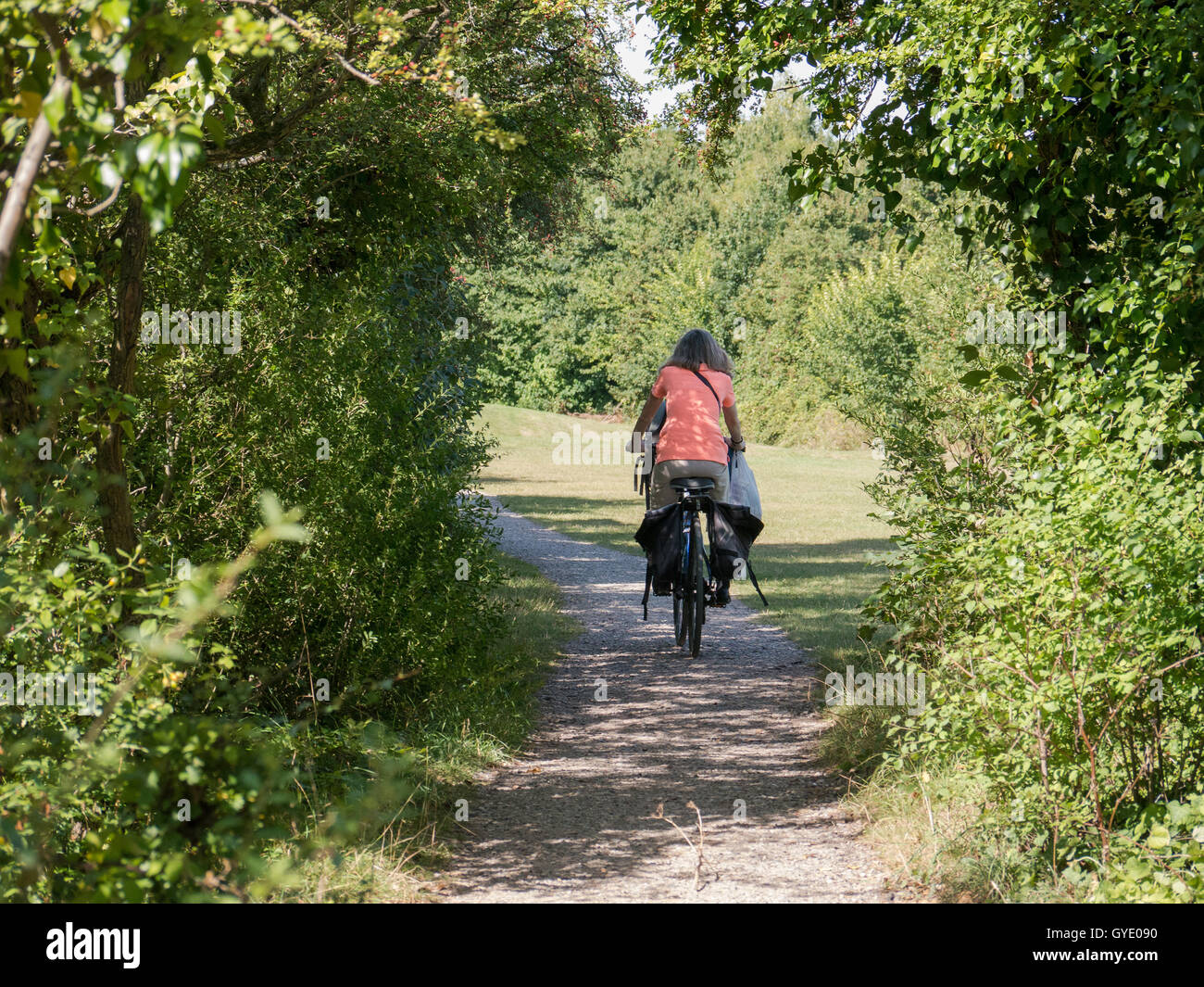 a lady riding her bike in the countryside Stock Photo - Alamy