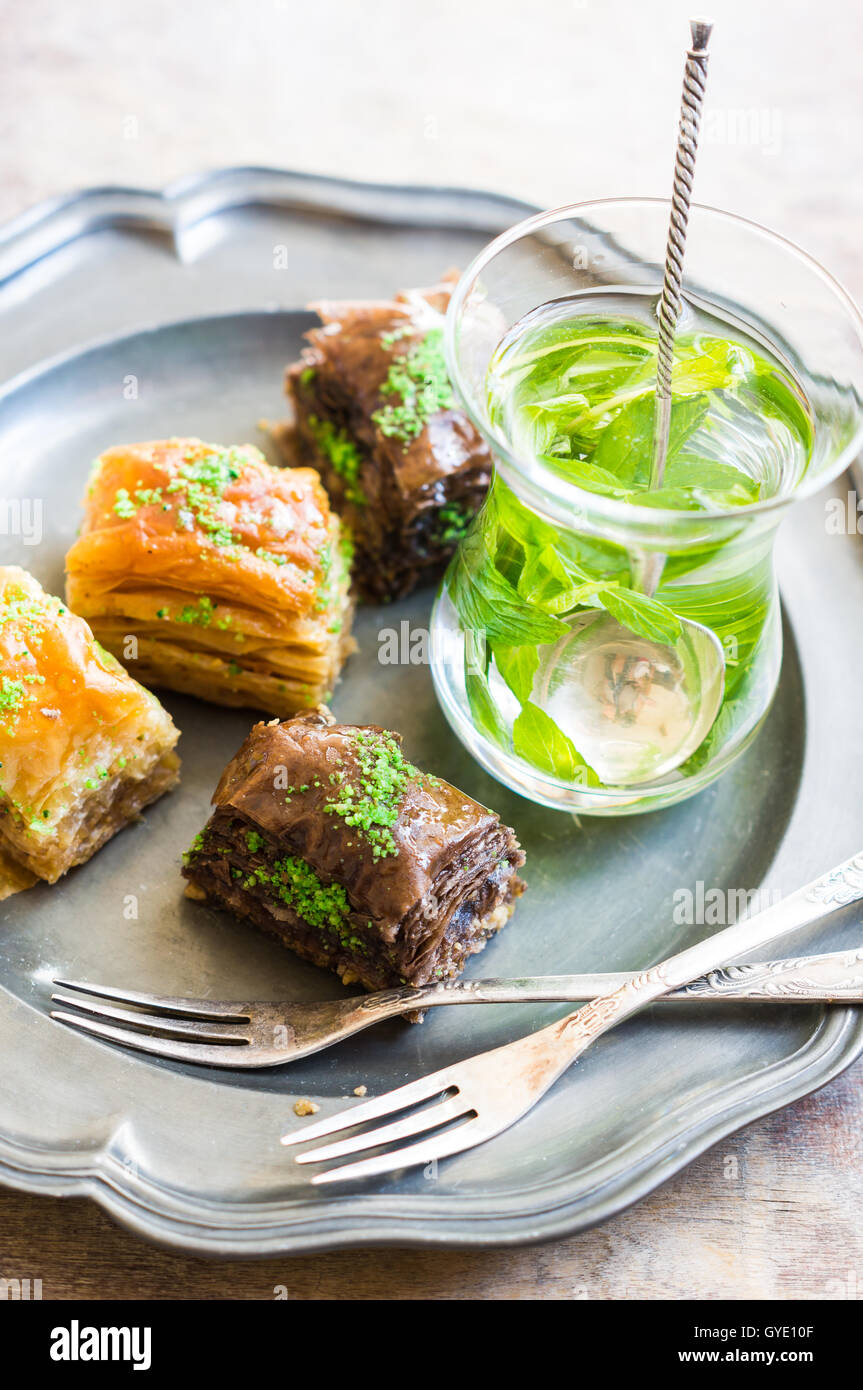 Traditional turkish dessert - mint tea and bakhlava on rustic ...