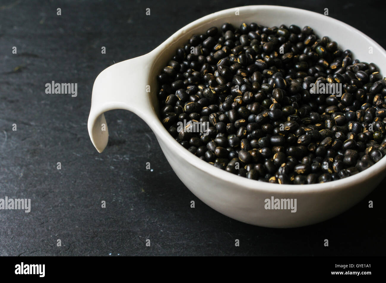 Black beans or Black turtle bean on the black stone background Stock ...
