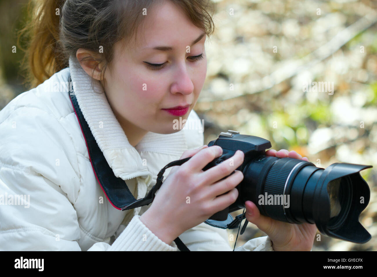 Portrait of nature photographer young woman (girl) preparing to take ...
