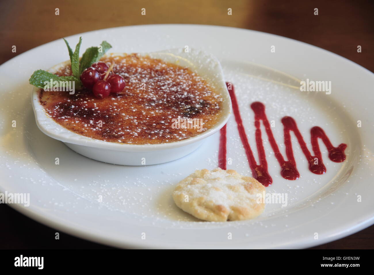Creme Brulee with a shortbread biscuit Stock Photo - Alamy