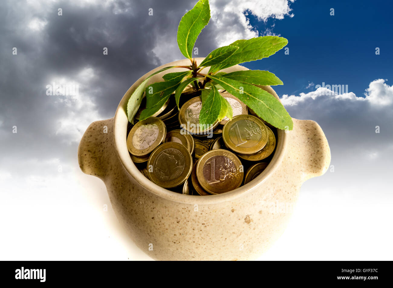 Pot of money under blue sky with clouds Stock Photo - Alamy