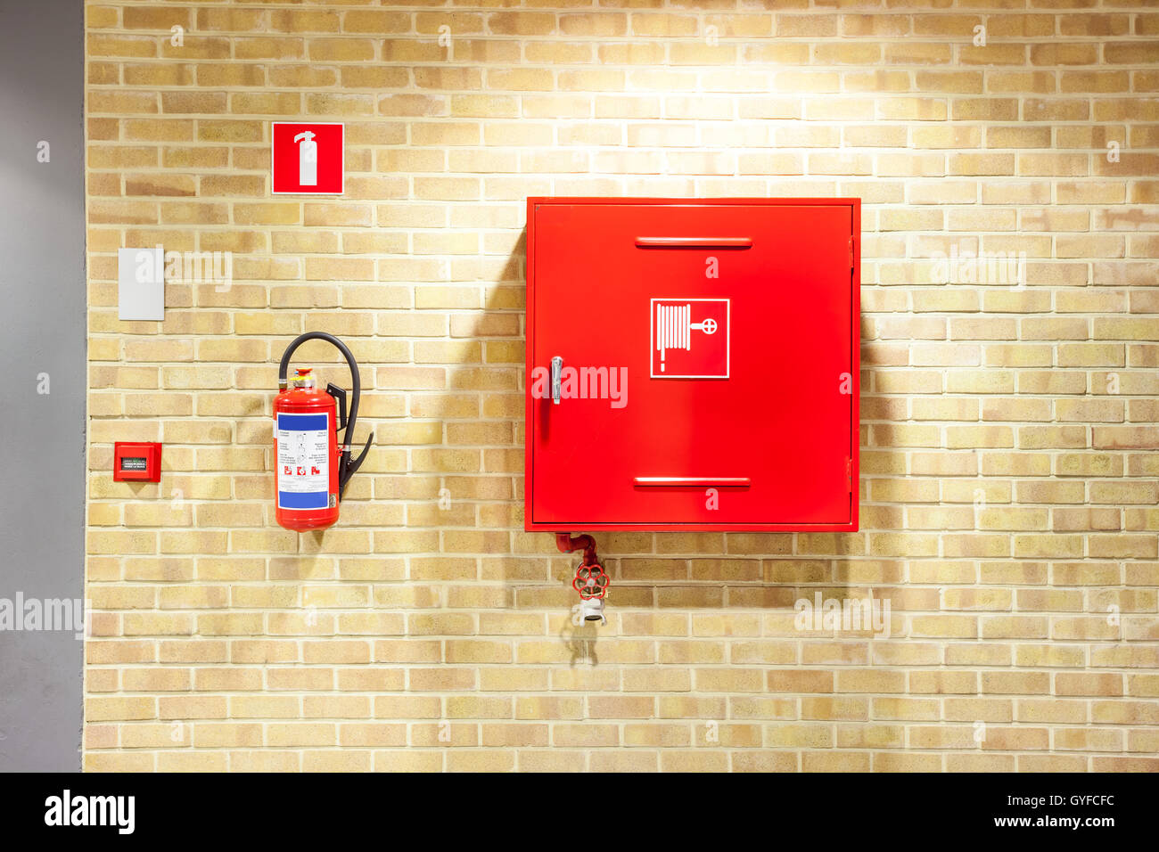 an fire hose hanging on the wall in an staircase Stock Photo - Alamy