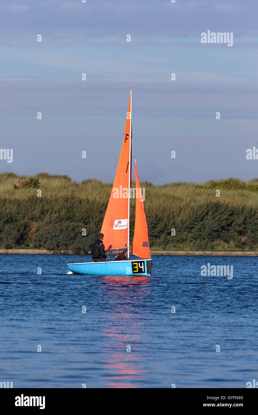 Yacht with orange sails, sailing on lake Stock Photo - Alamy
