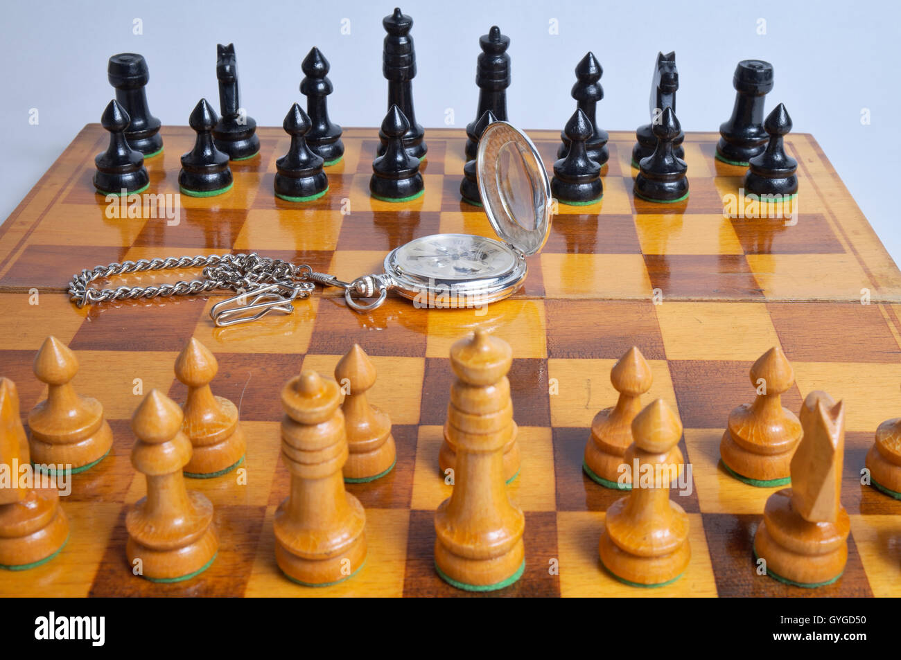 Pocket watch on top of a wooden chessboard. Sports and leisure Stock ...