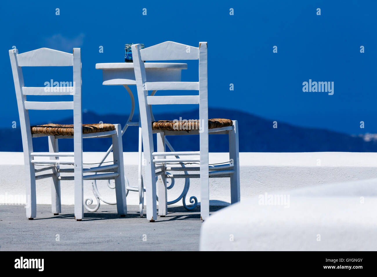 Two chairs and a table facing the Caldera scenic view in Thira, Fira ...