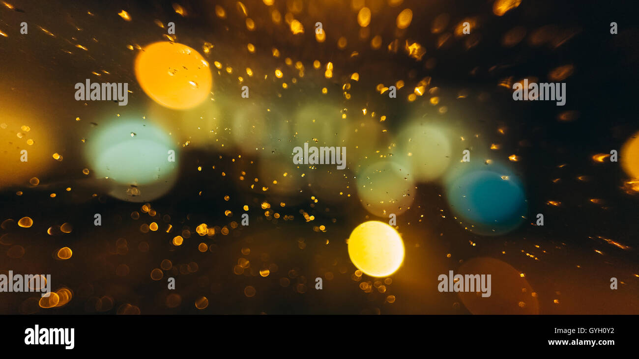 Glowing Lights On Unfocused Bokeh Blurred Dark Background Stock Photo ...