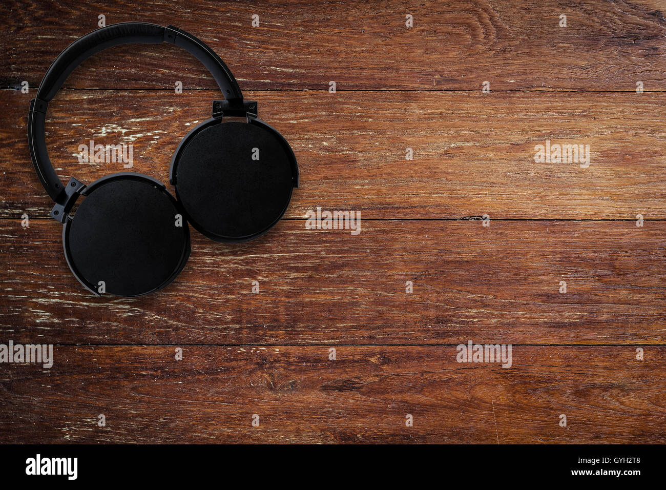 Headphone on wood background and texture with space Stock Photo - Alamy
