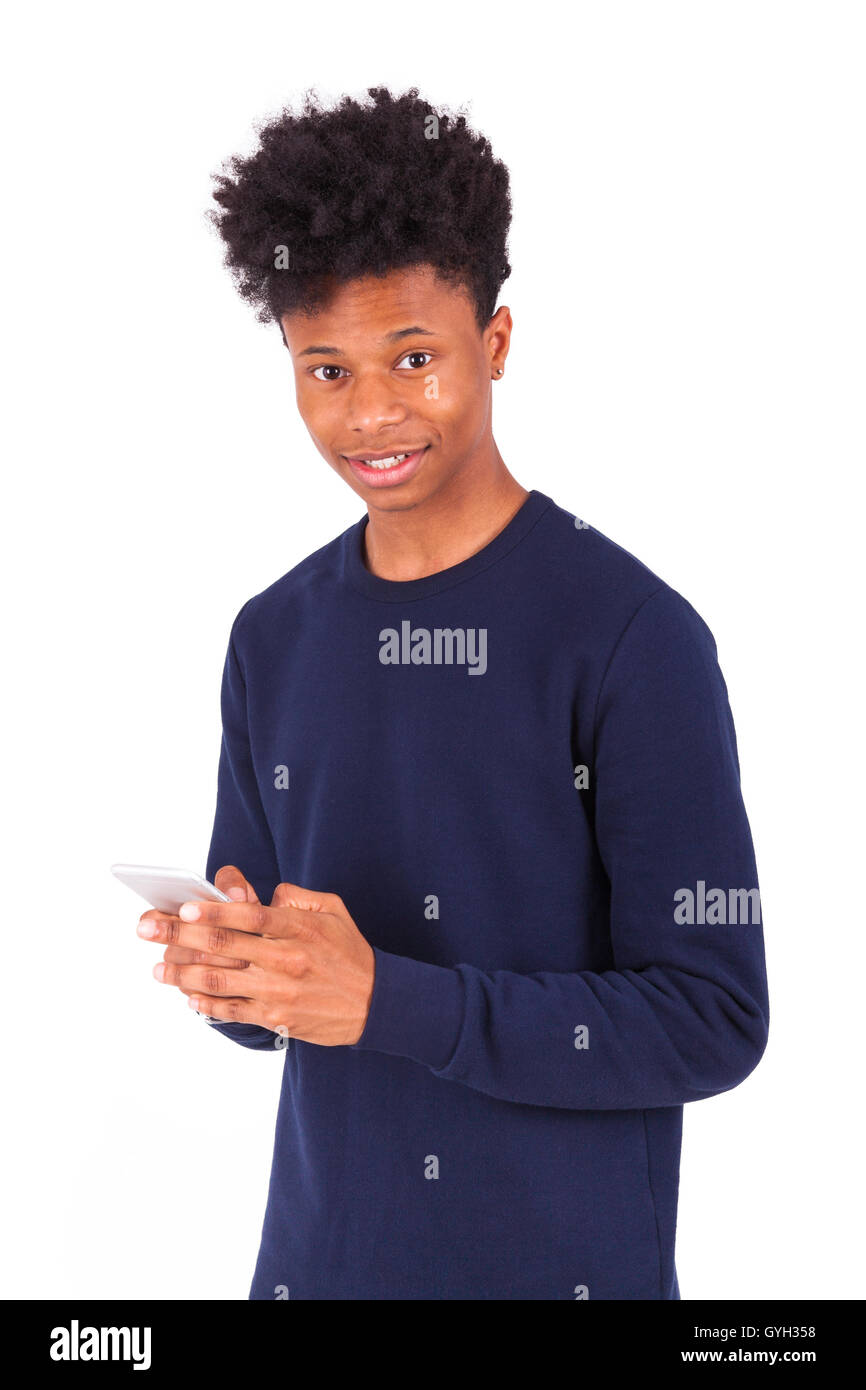 Young African American man sending a sms text message on his smartphone ...