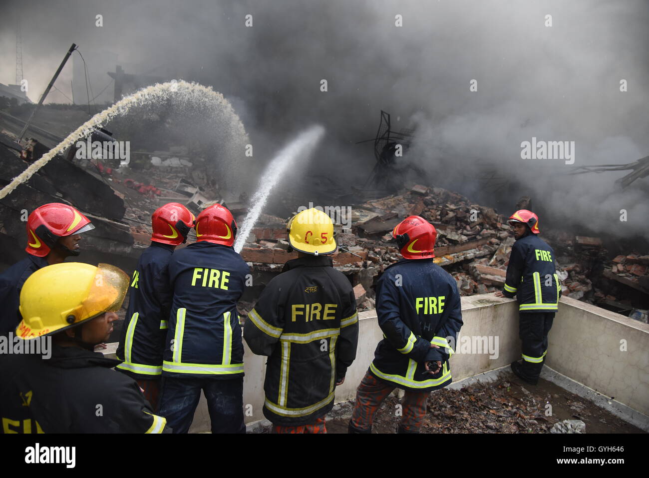Firefighters work to put out a fire at a Tampaco packaging factory in ...