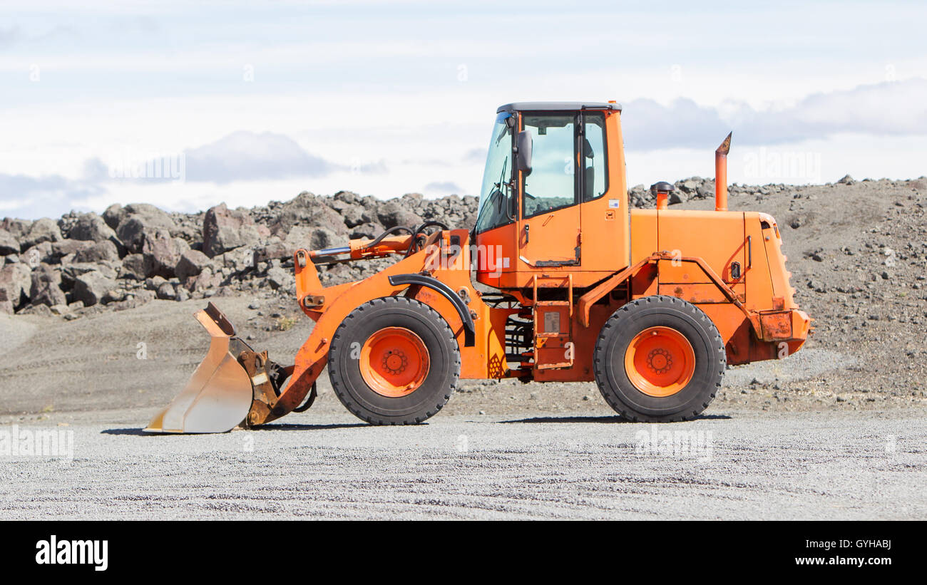 Large orange bulldozer on a building site Stock Photo - Alamy