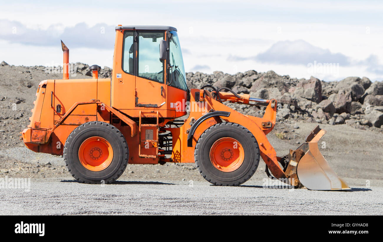 Large orange bulldozer on a building site Stock Photo - Alamy