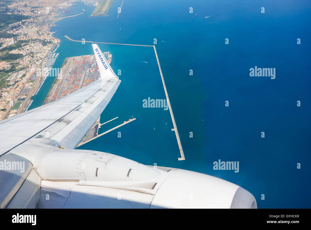 Ryanair flight leaving Genoa airport over shipping port Stock Photo - Alamy