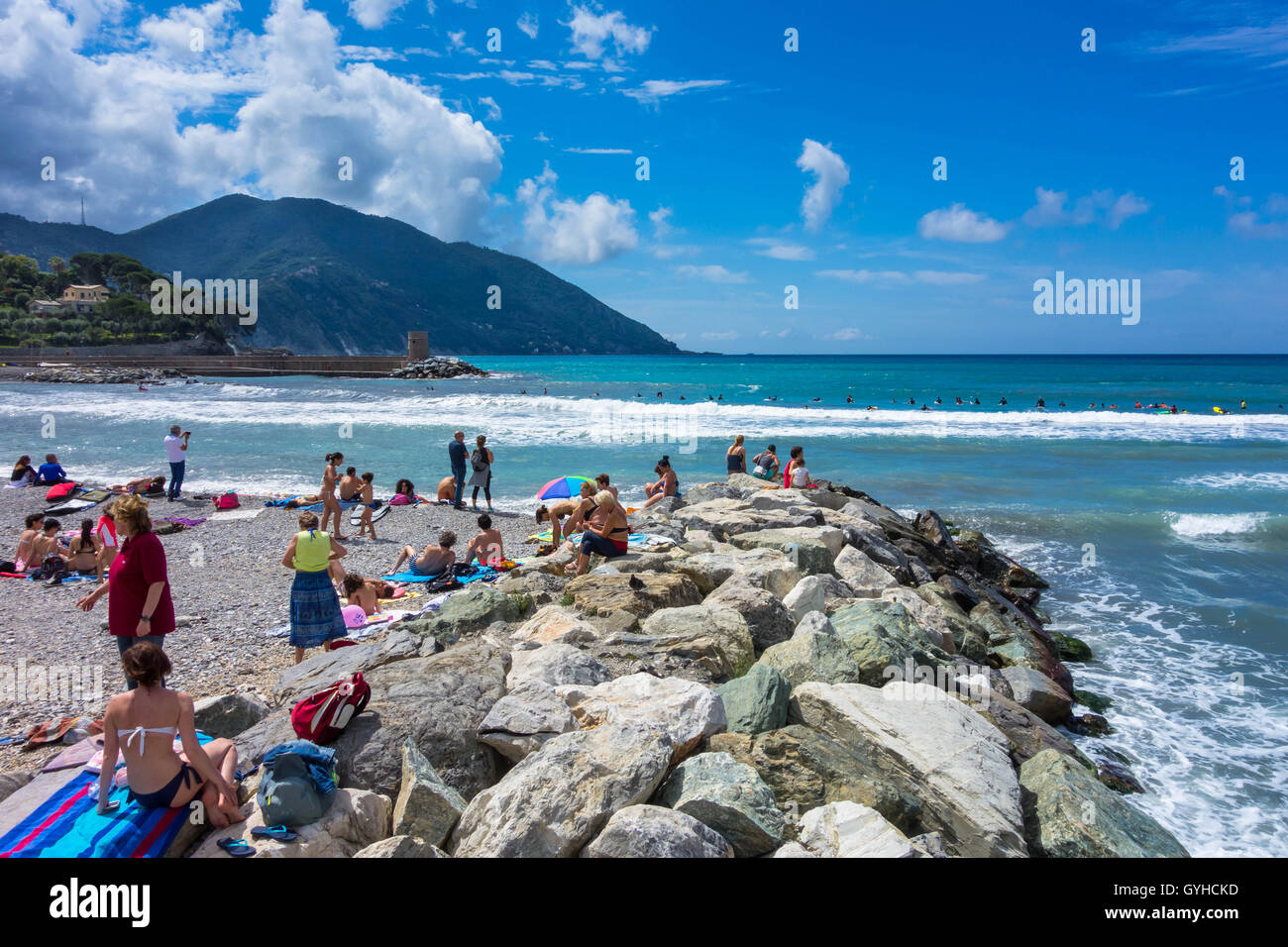 Spectators gathering on Rocco beach Italy to watch a surfing ...