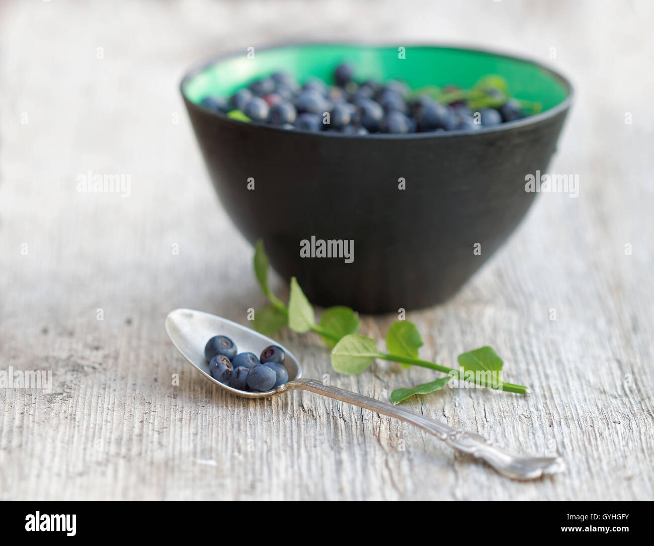 Blueberry in a bowl and a silver spoone. Short depth of focus Stock ...