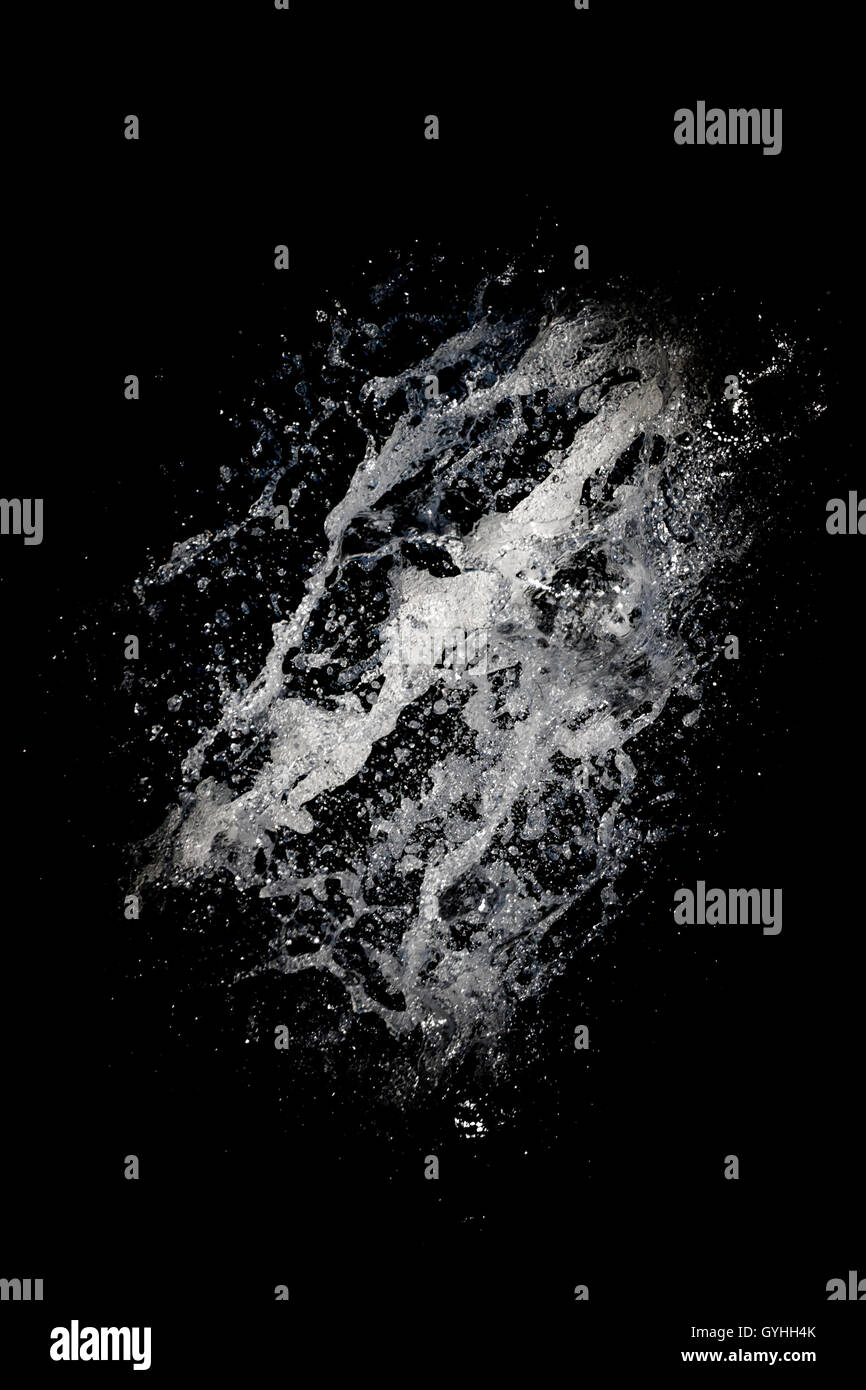 Clear fresh water splashing in the air behind a black background Stock ...