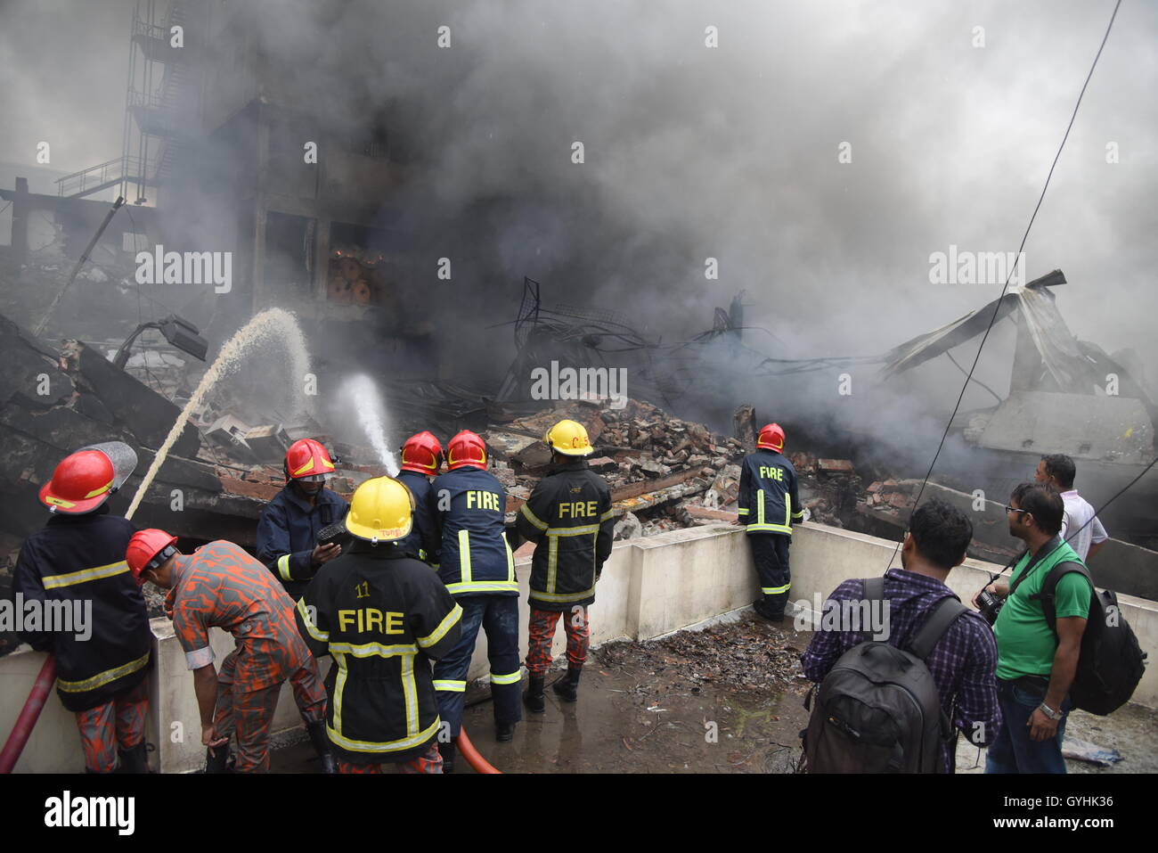 Firefighters work to put out a fire at a Tampaco packaging factory in ...