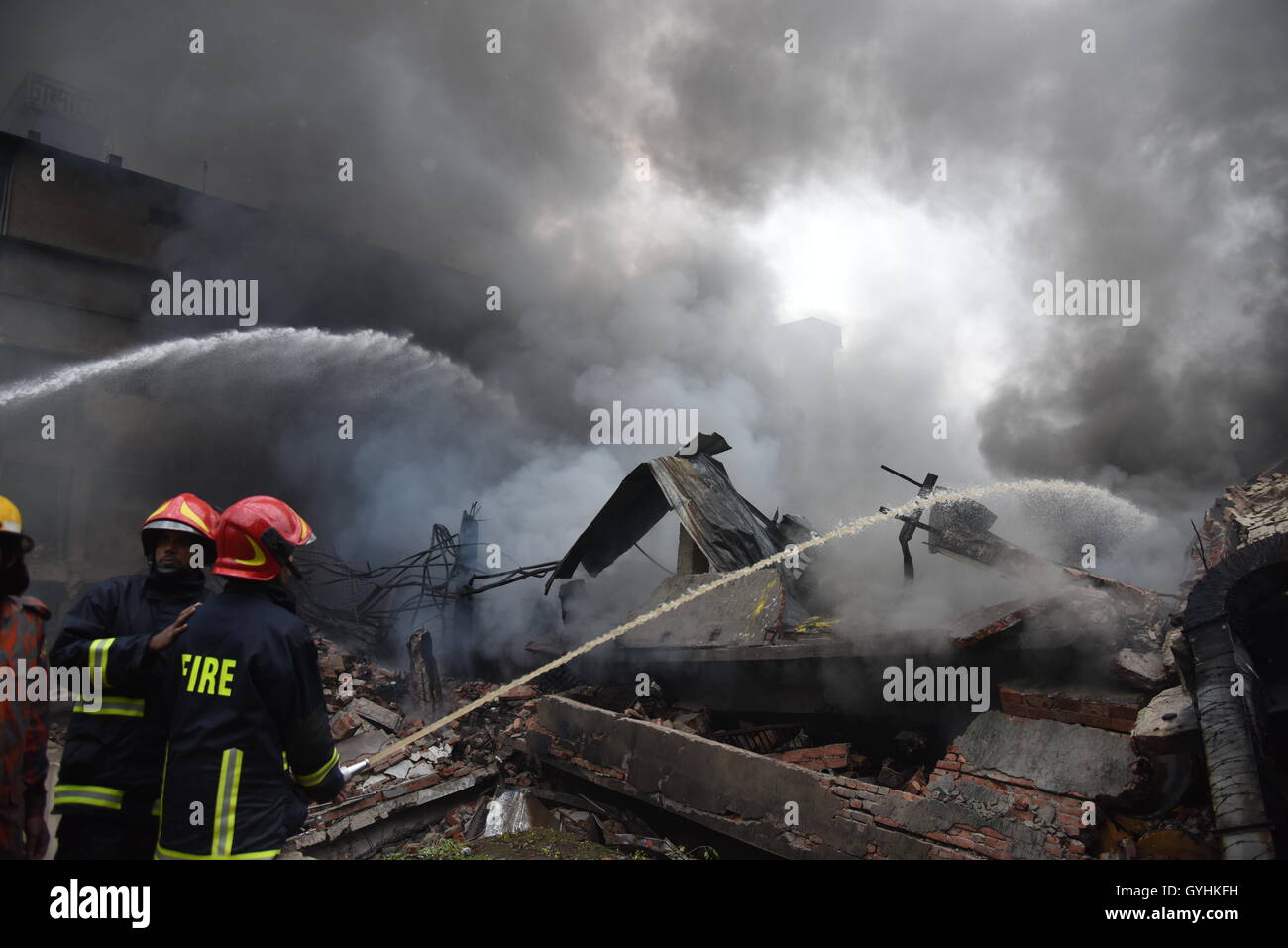 Firefighters work to put out a fire at a Tampaco packaging factory in ...