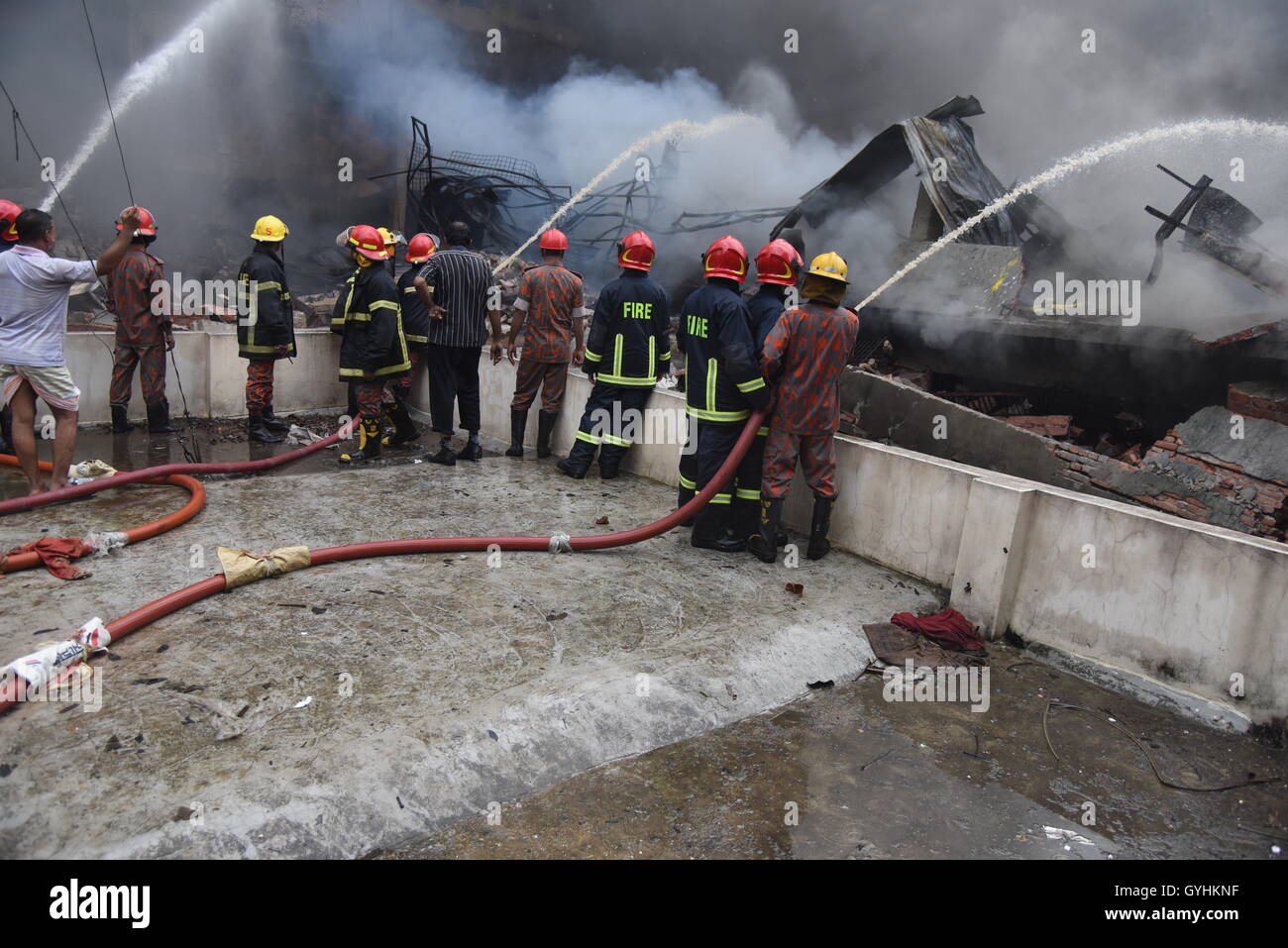 Firefighters work to put out a fire at a Tampaco packaging factory in ...