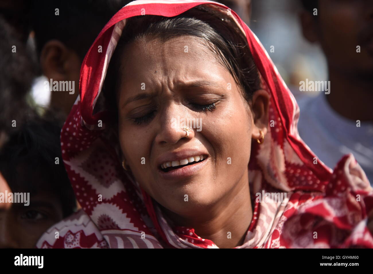 Relative of a fire victim cries as victims' bodies are carried into a ...
