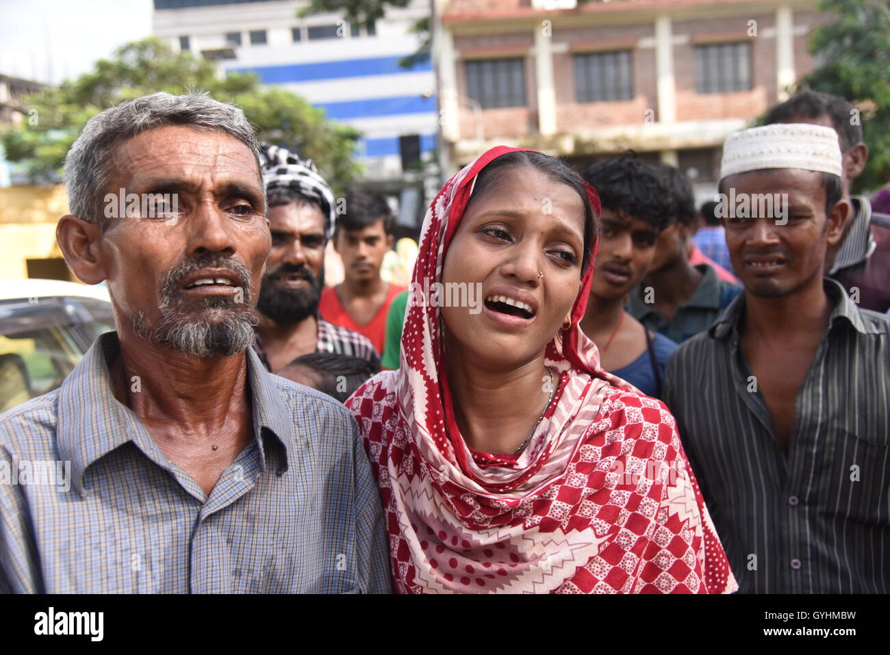 Relative of a fire victim cries as victims' bodies are carried into a ...