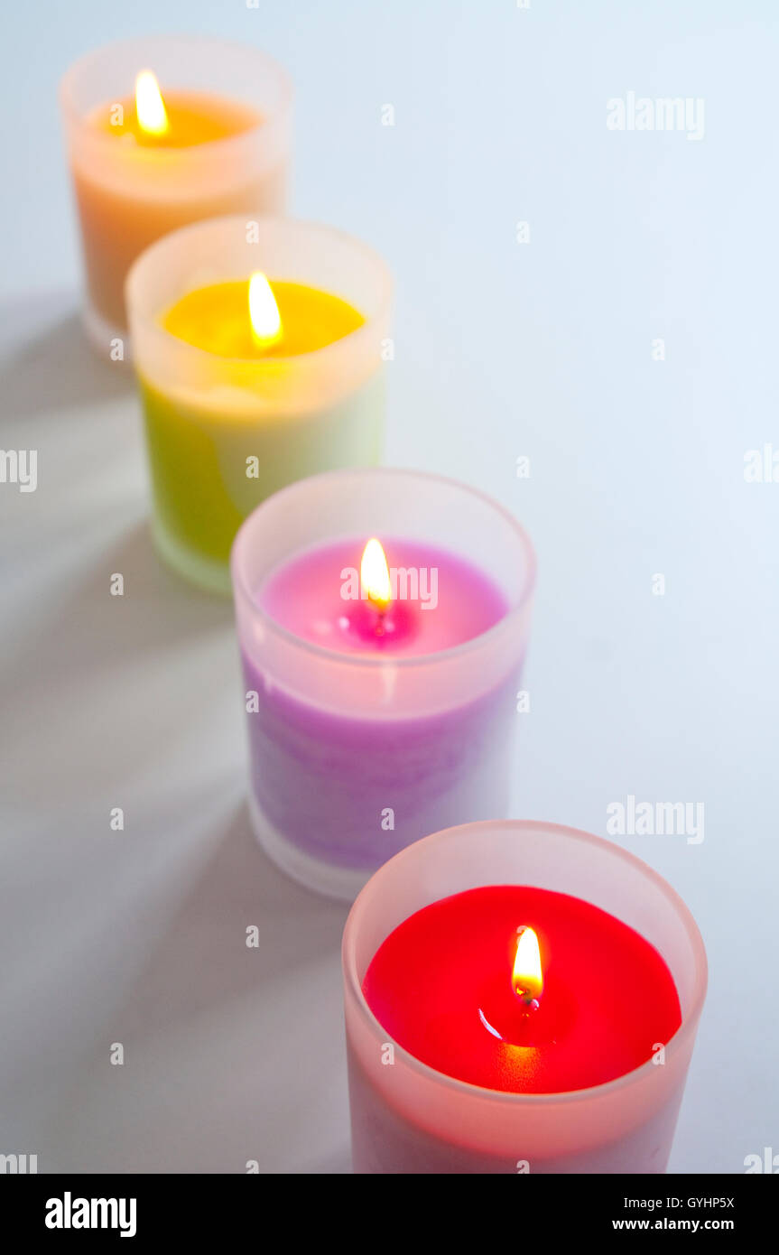 Four lit up candles Stock Photo - Alamy