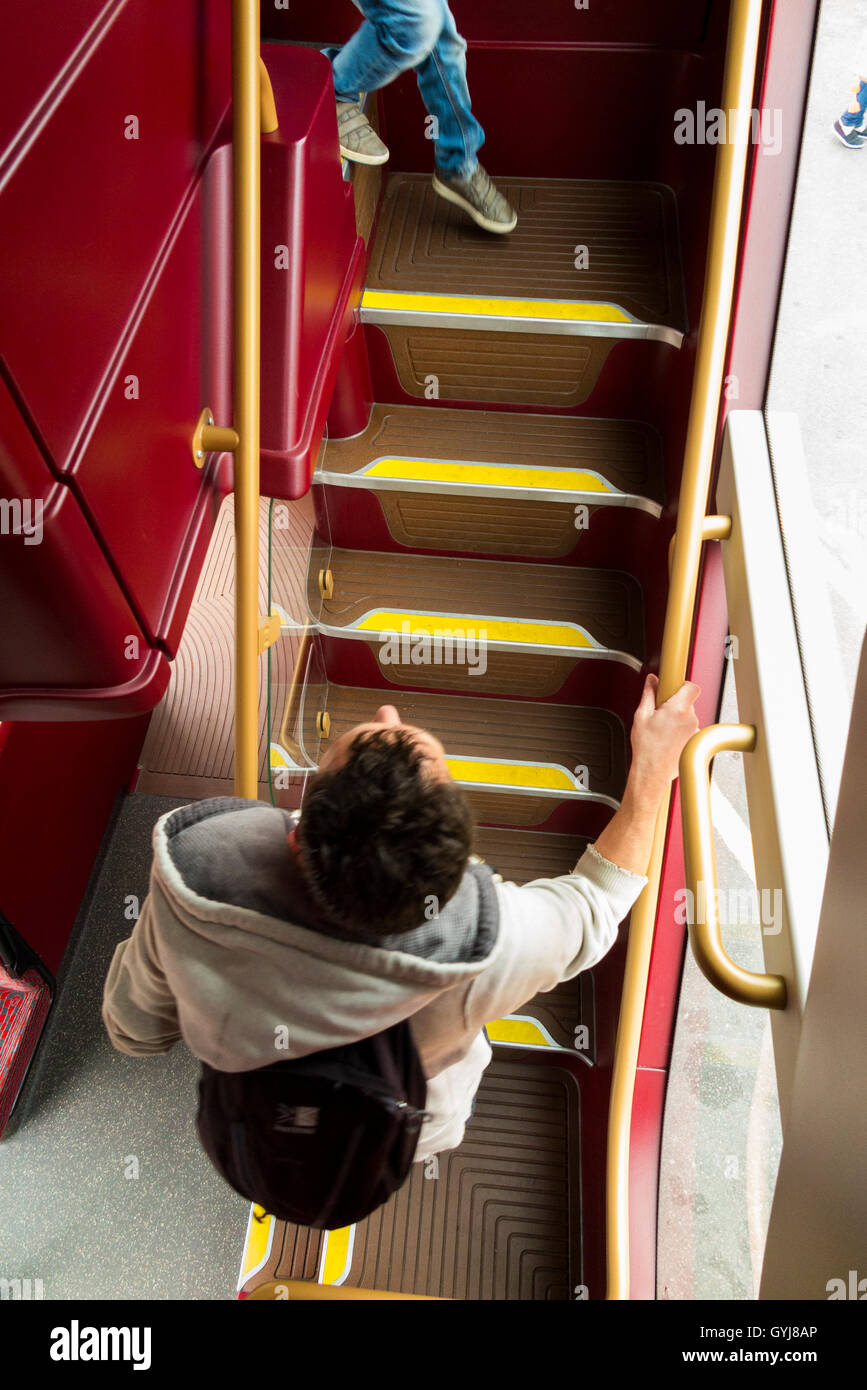 Passengers climb ascend walk up the passenger stairs / stair case steps ...