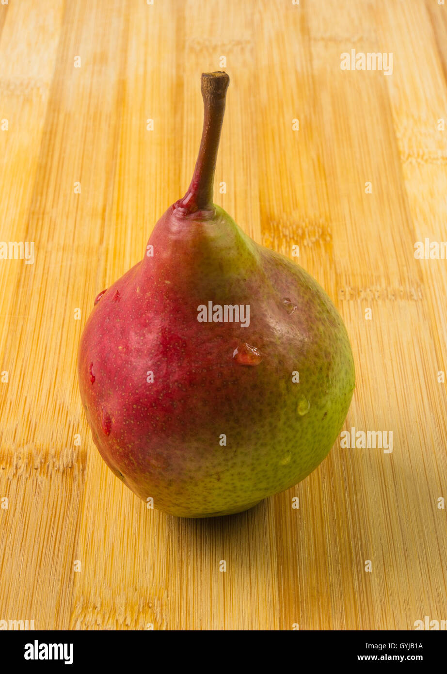 ripe colorful pear on a wooden background Stock Photo - Alamy
