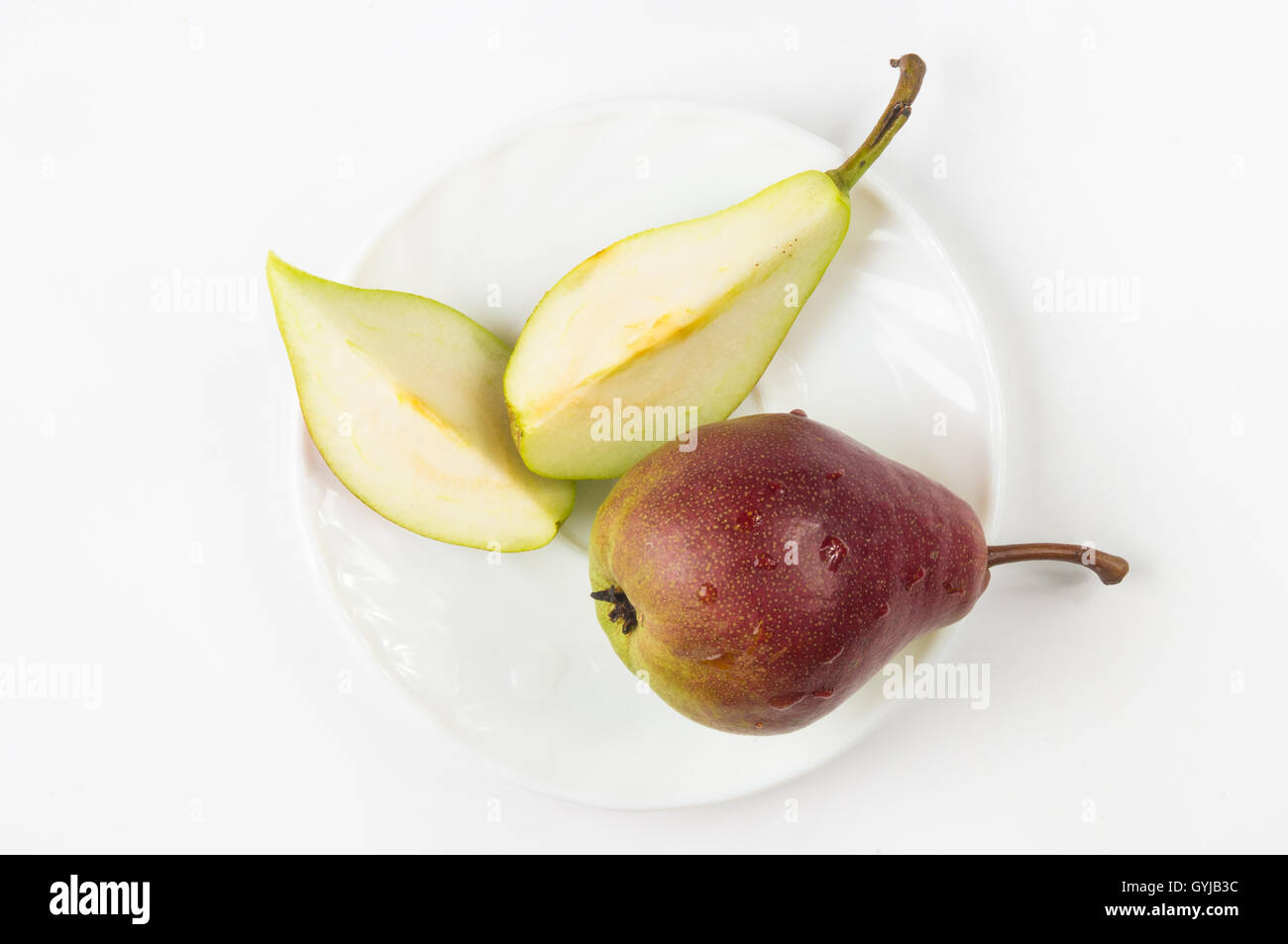 colorful pears and slices in the dish on a white background Stock Photo ...