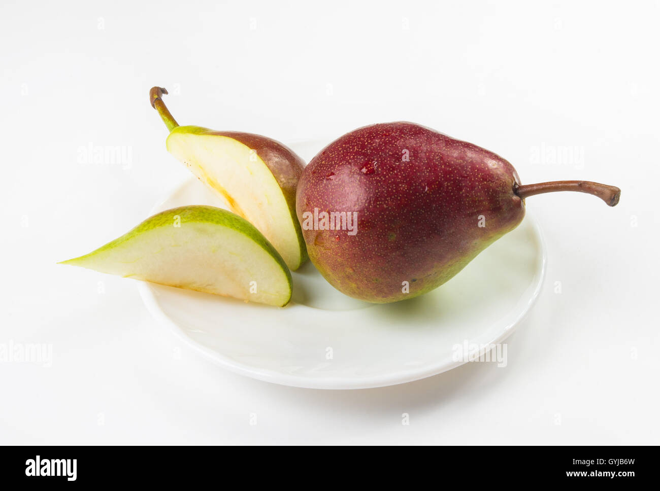 colorful pears and slices in the dish on a white background Stock Photo ...