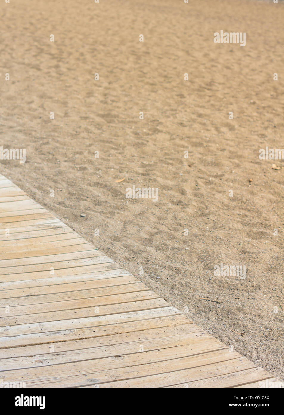 Sandy beach on sunny day with wooden walkway Stock Photo - Alamy