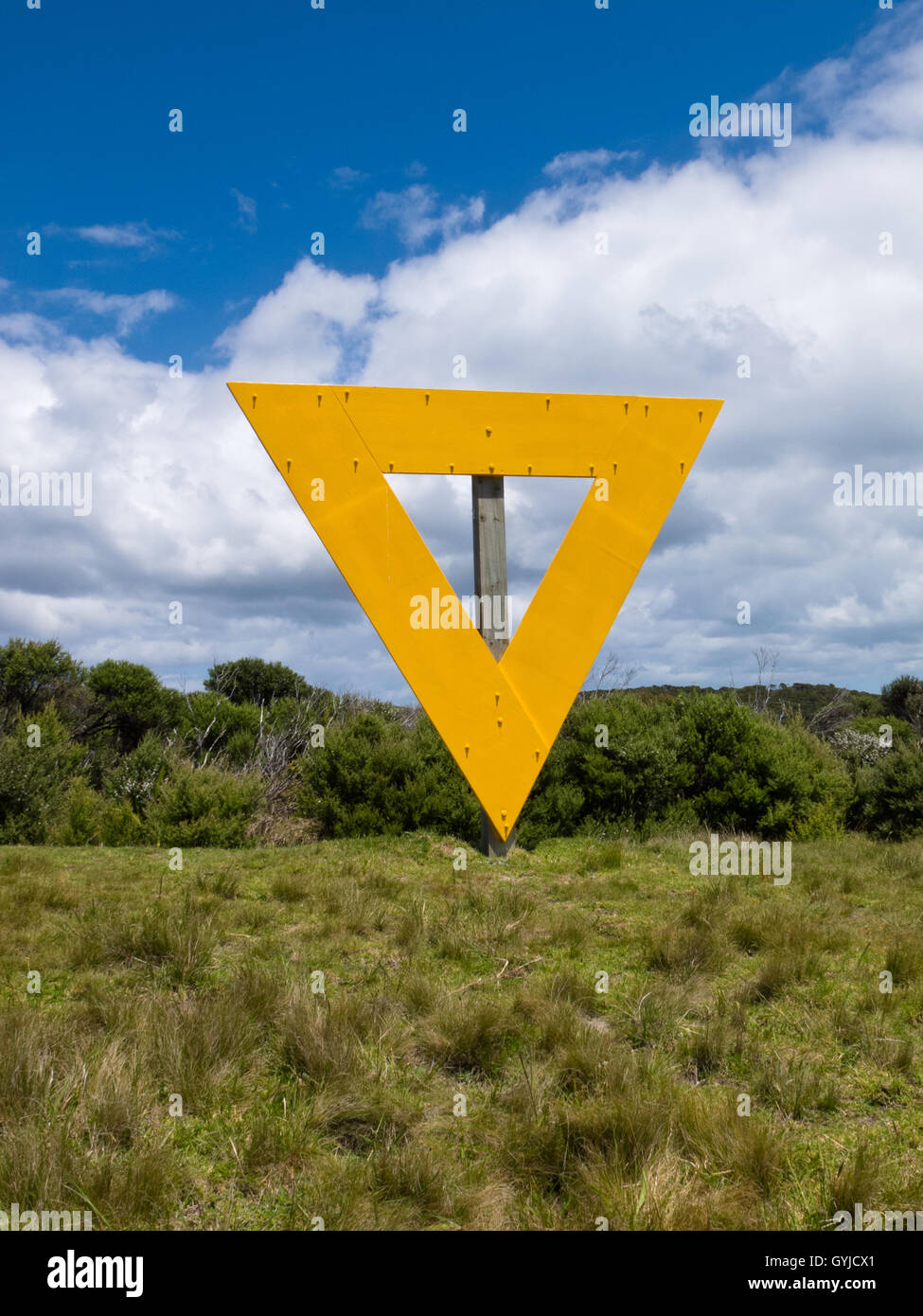 Shipping navigation yellow triangle sign on land Stock Photo - Alamy