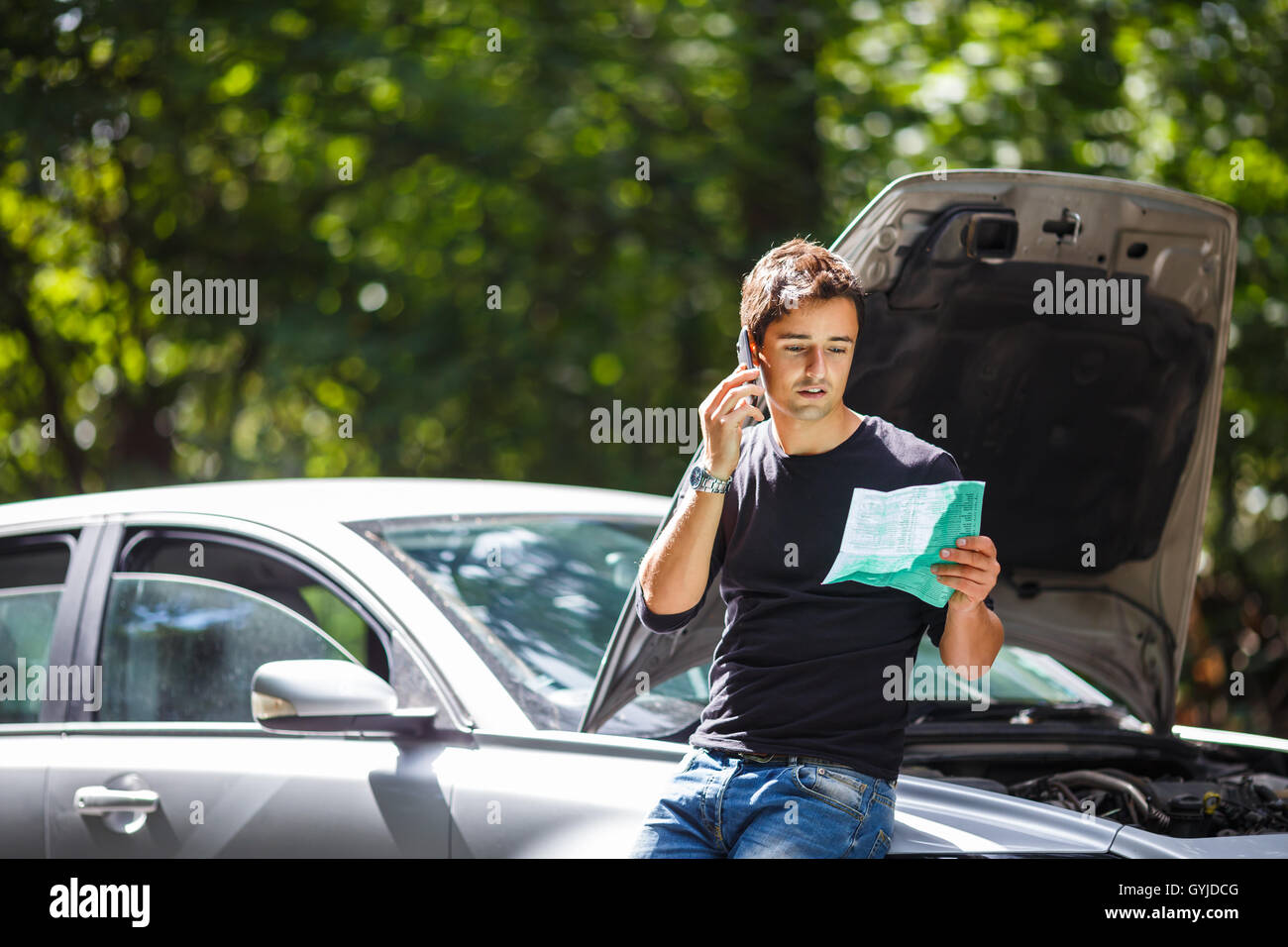 Handsome young man calling for assistance with his car broken do Stock ...