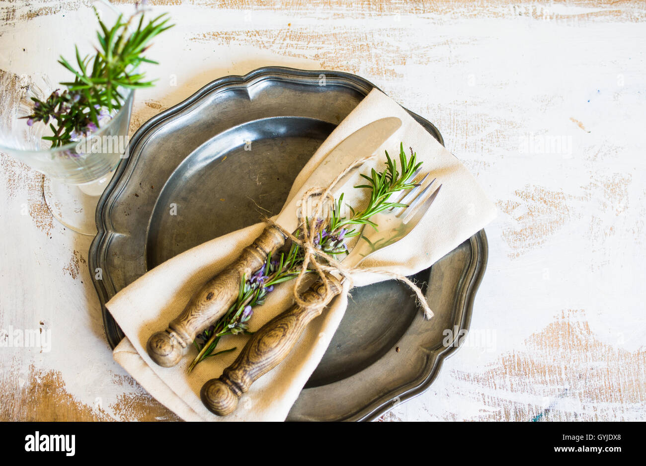 Summer time table setting with fresh rosemary spice on rustic ...