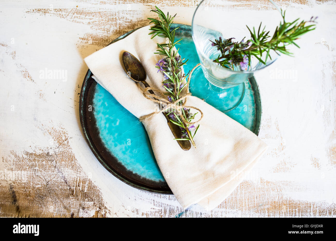 Summer time table setting with fresh rosemary spice on rustic ...
