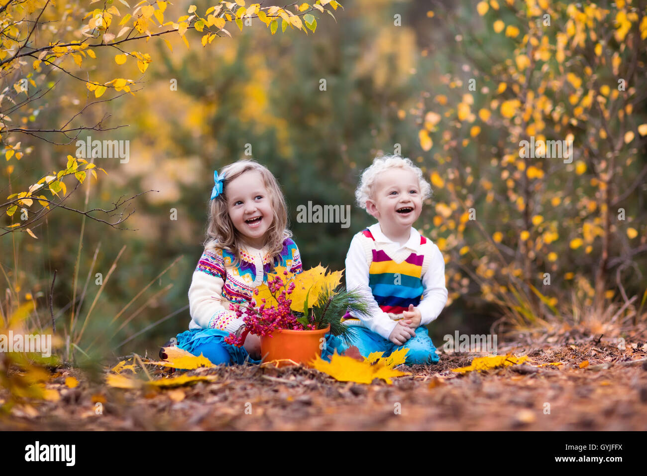 Happy children playing in beautiful autumn park on warm sunny fall day ...