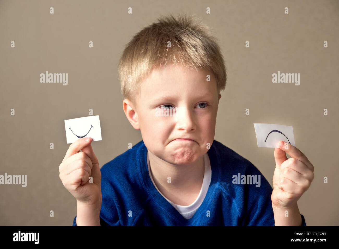 Young boy select between positive and negative expressions Stock Photo ...