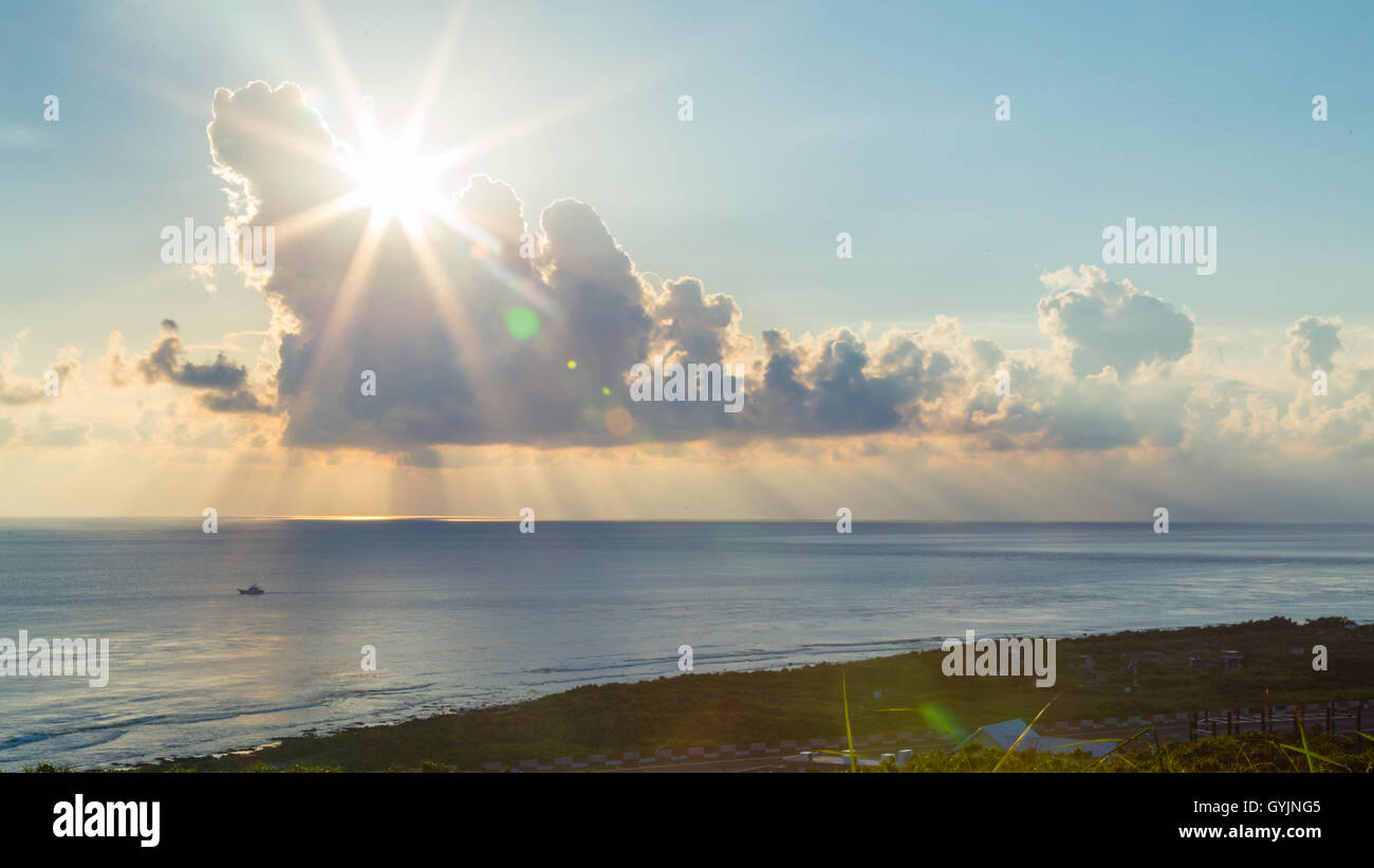 Sun going down behind dramatic clouds Stock Photo - Alamy