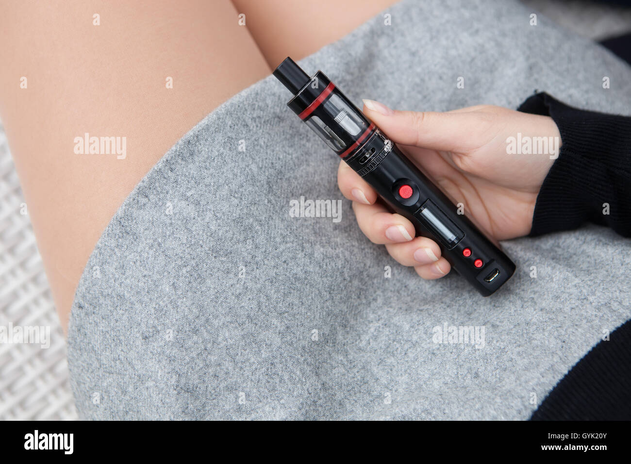 Vaping device in female vaper hands.Modern e-cig gadget to smoke ...
