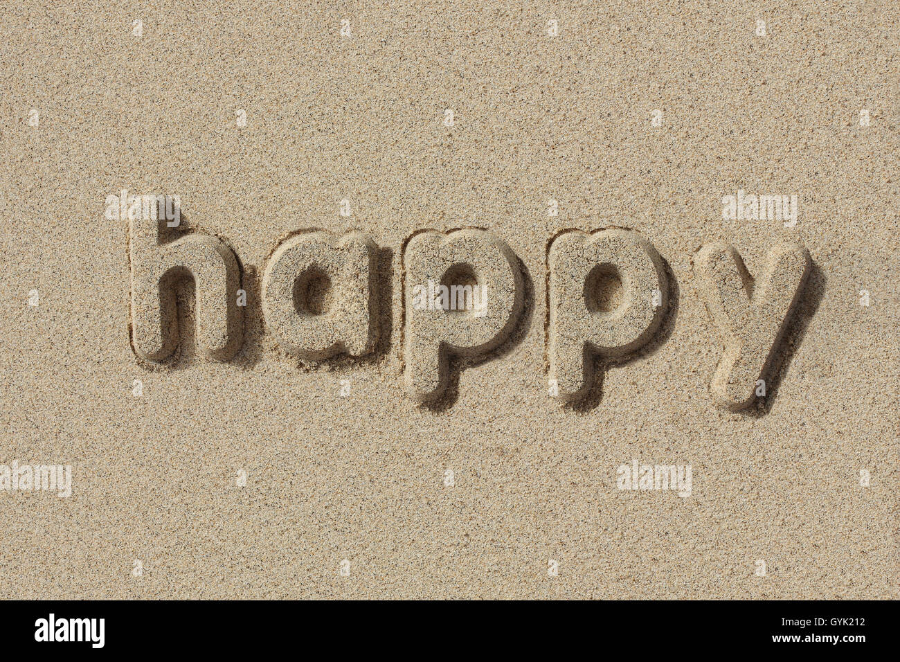 Happy written in sand letters. Very simple and graphic Stock Photo - Alamy