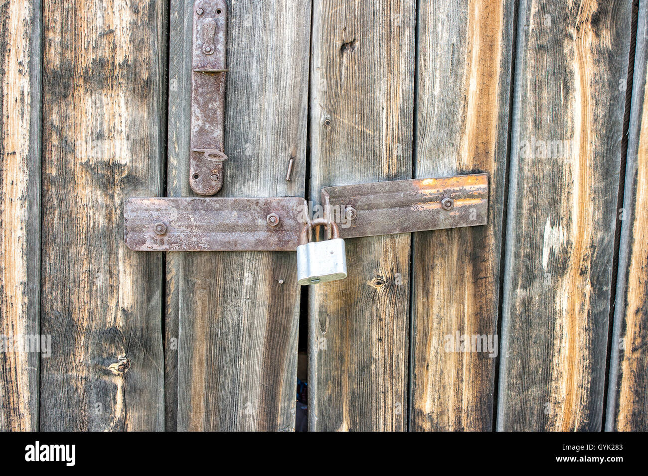 lock on the old wooden gate closeup Stock Photo - Alamy