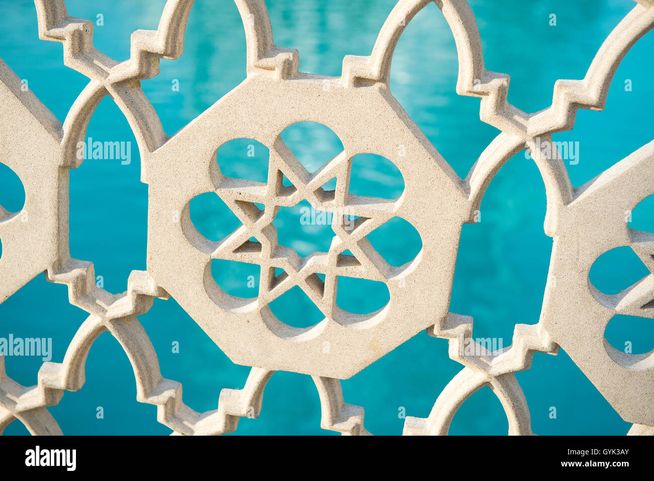 Islamic star pattern architectural detail on fence in front of bright ...