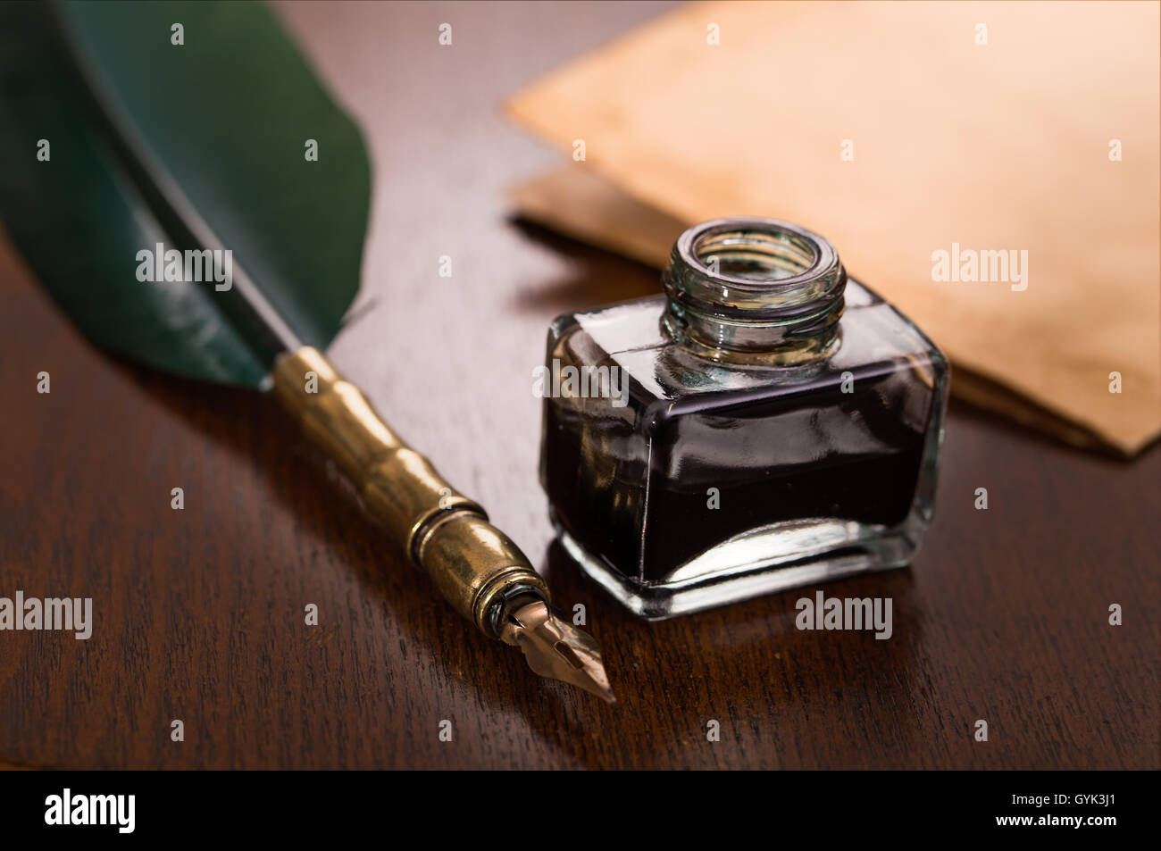Quill Pen Ink Well And Parchment Paper Stock Photo