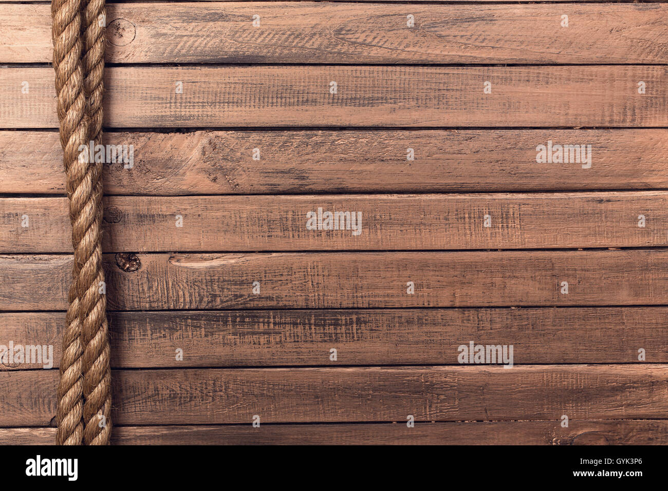 Rope on old wooden board vertical Stock Photo - Alamy