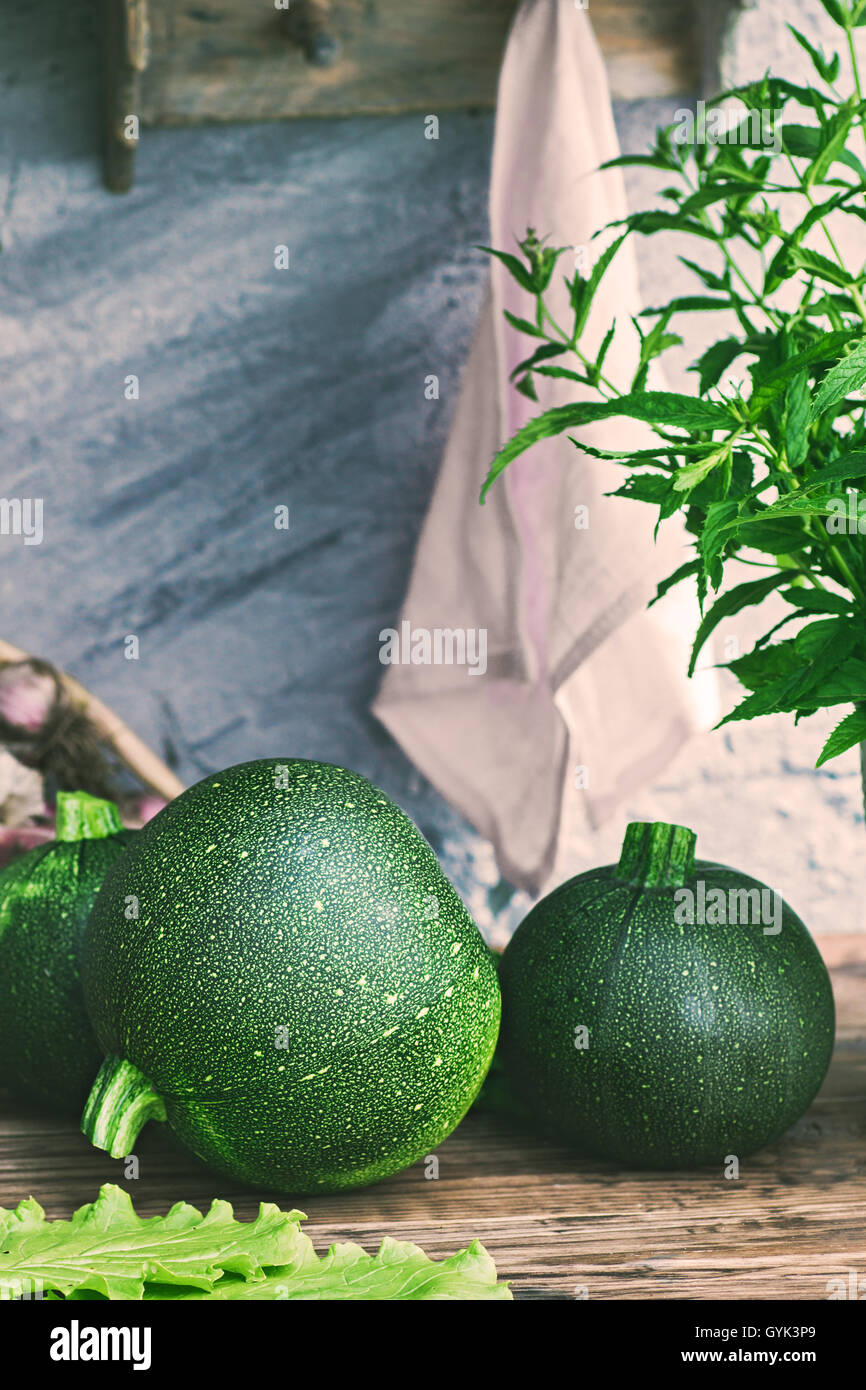 Round zucchini on rustic table Stock Photo - Alamy